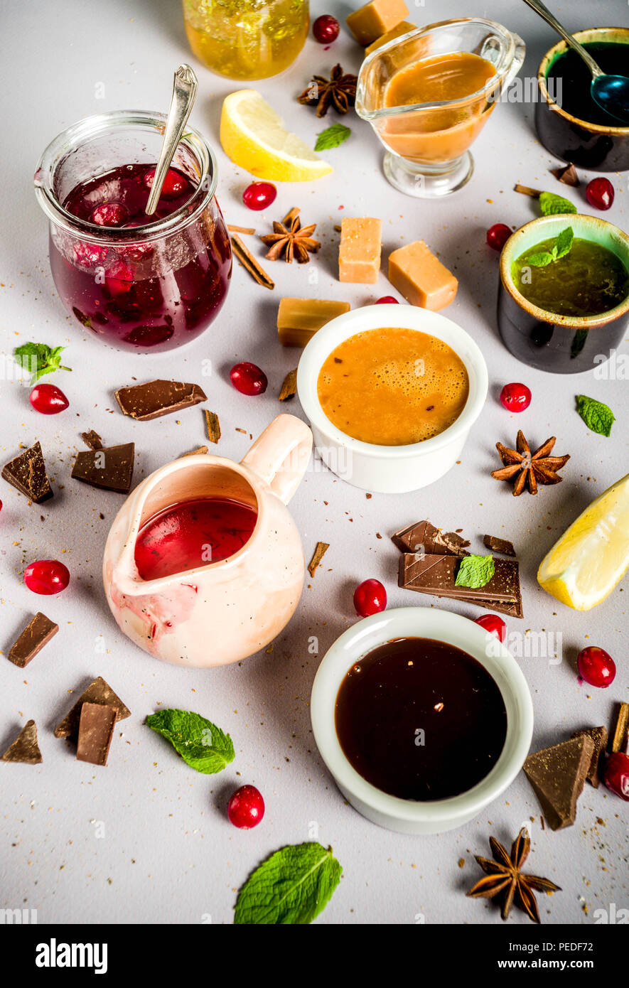 Various sweet sauces, toppings and syrups - lemon, orange, caramel ...