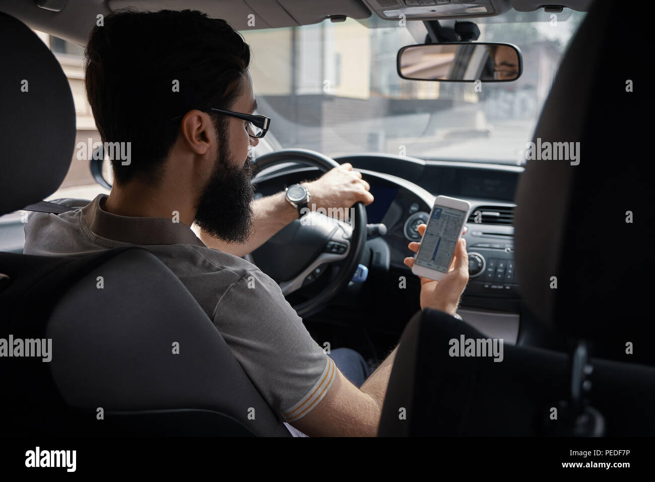 Man using mobile phone while driving Stock Photo - Alamy