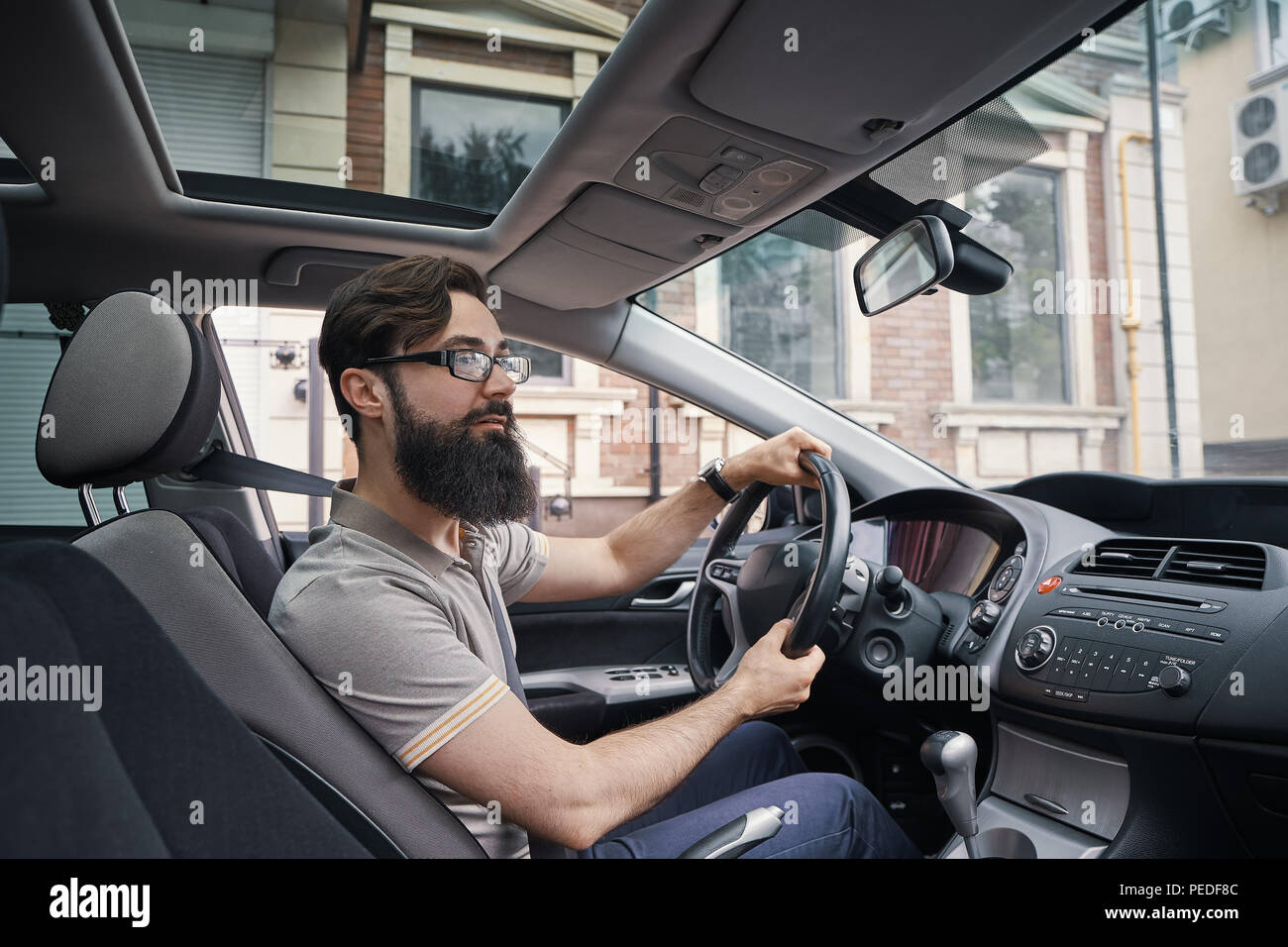 Young man driving car hi-res stock photography and images - Alamy