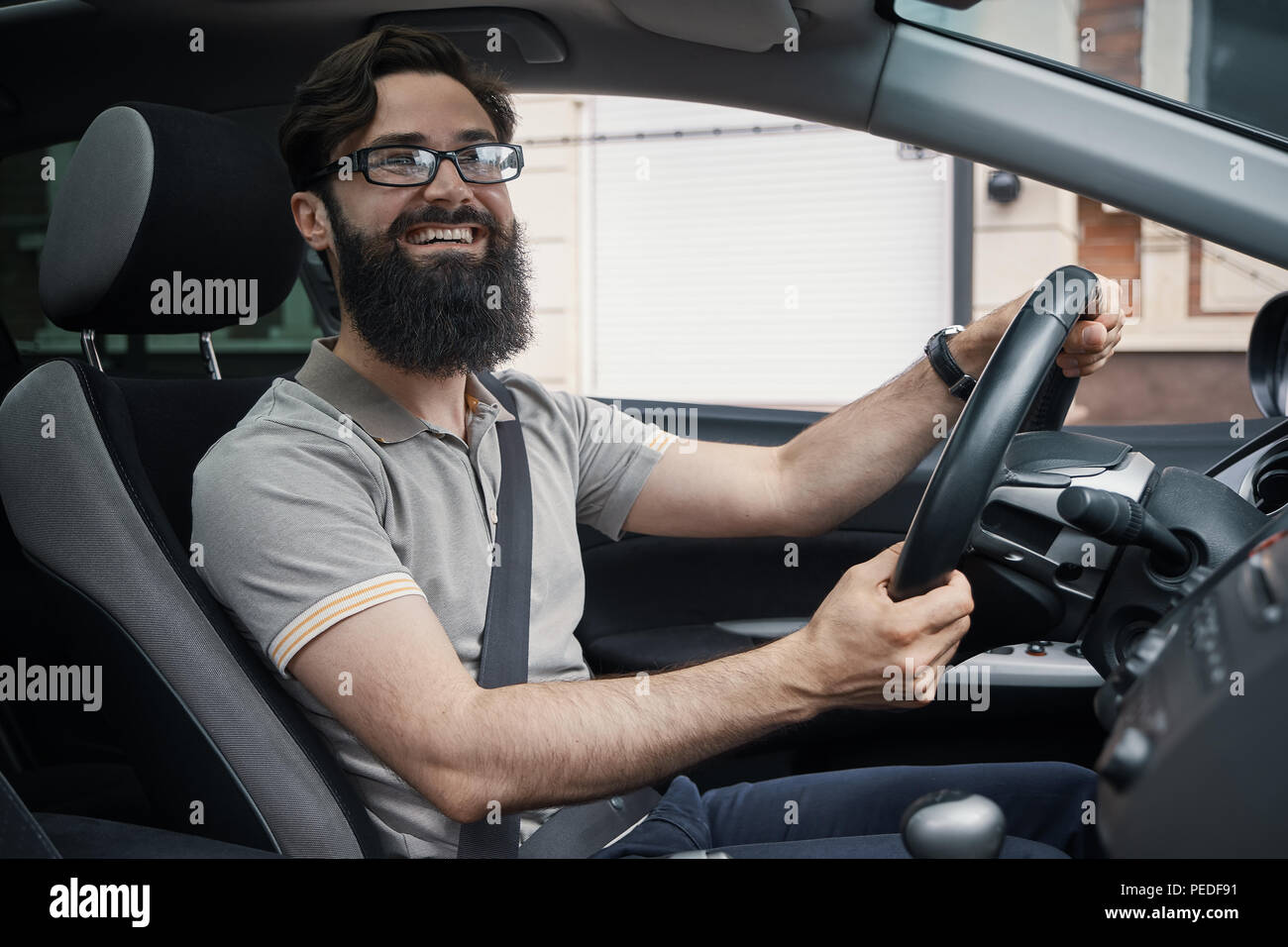 Happy charismatic man driving a car Stock Photo - Alamy