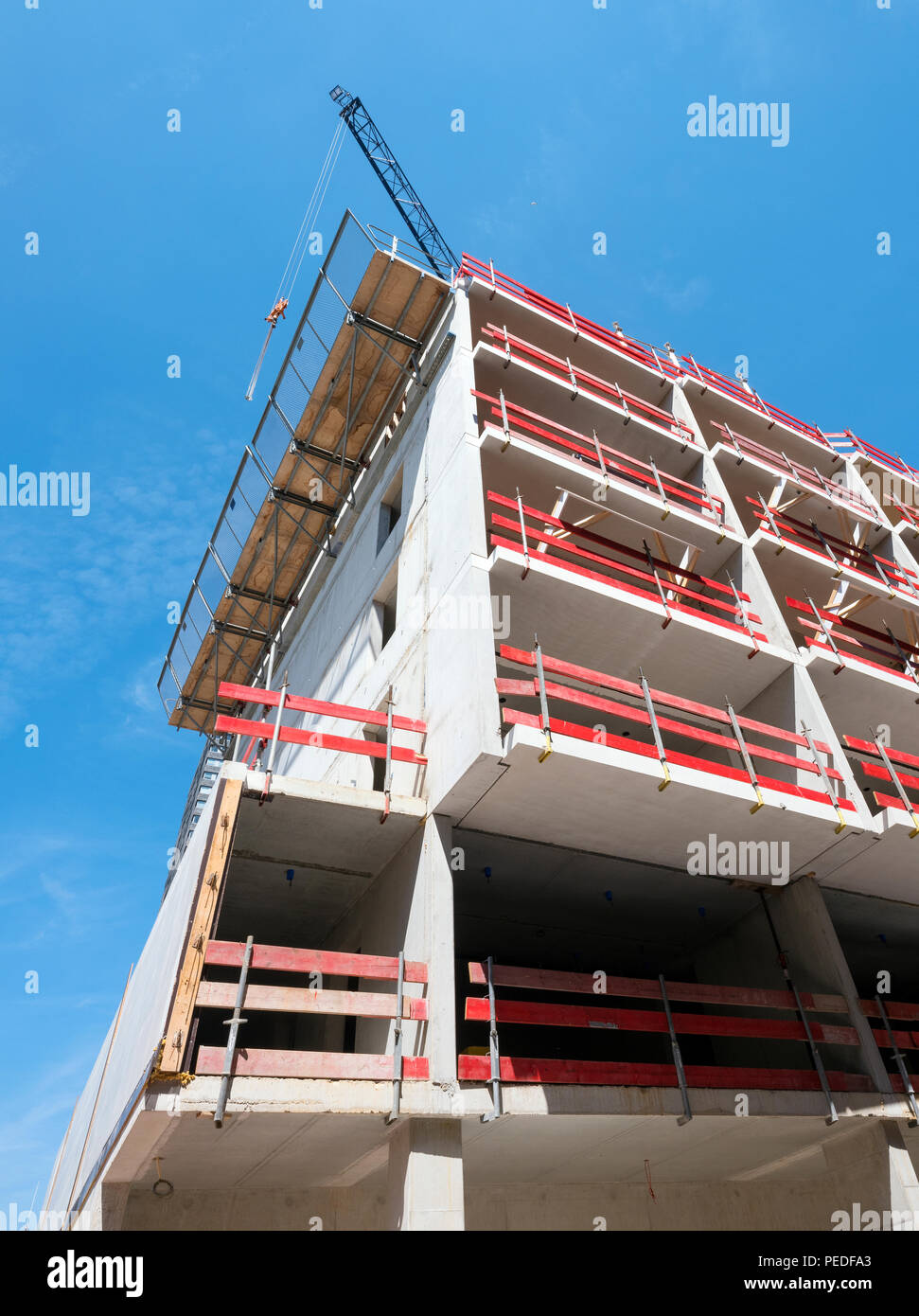 construction site with concrete structure and red planks for safety ...