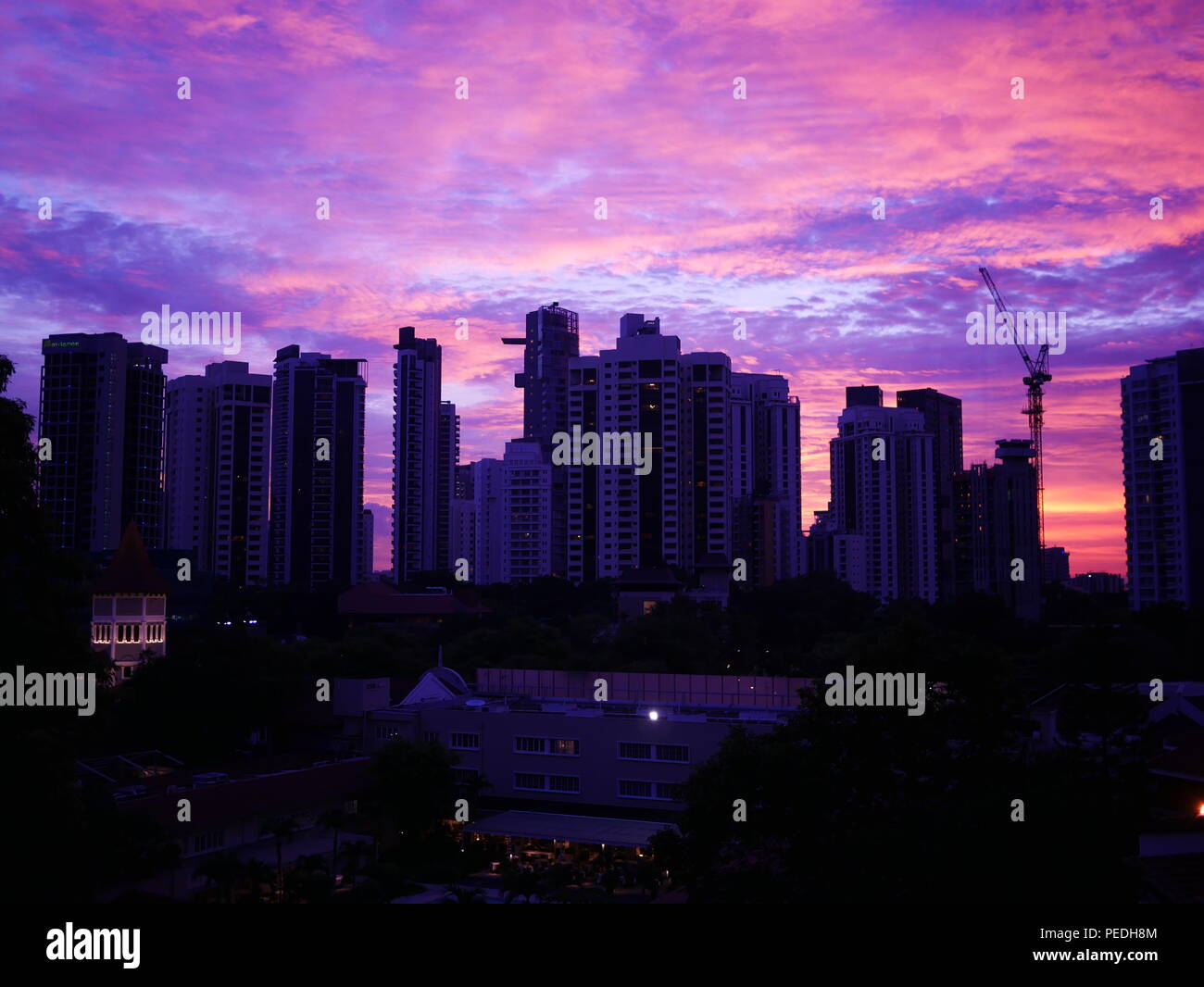 Sunset behind buildings with beautiful cloudy sky. Beautiful red ...
