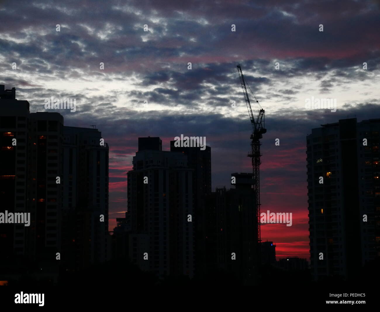 Sunset behind buildings with beautiful cloudy sky. Beautiful red ...