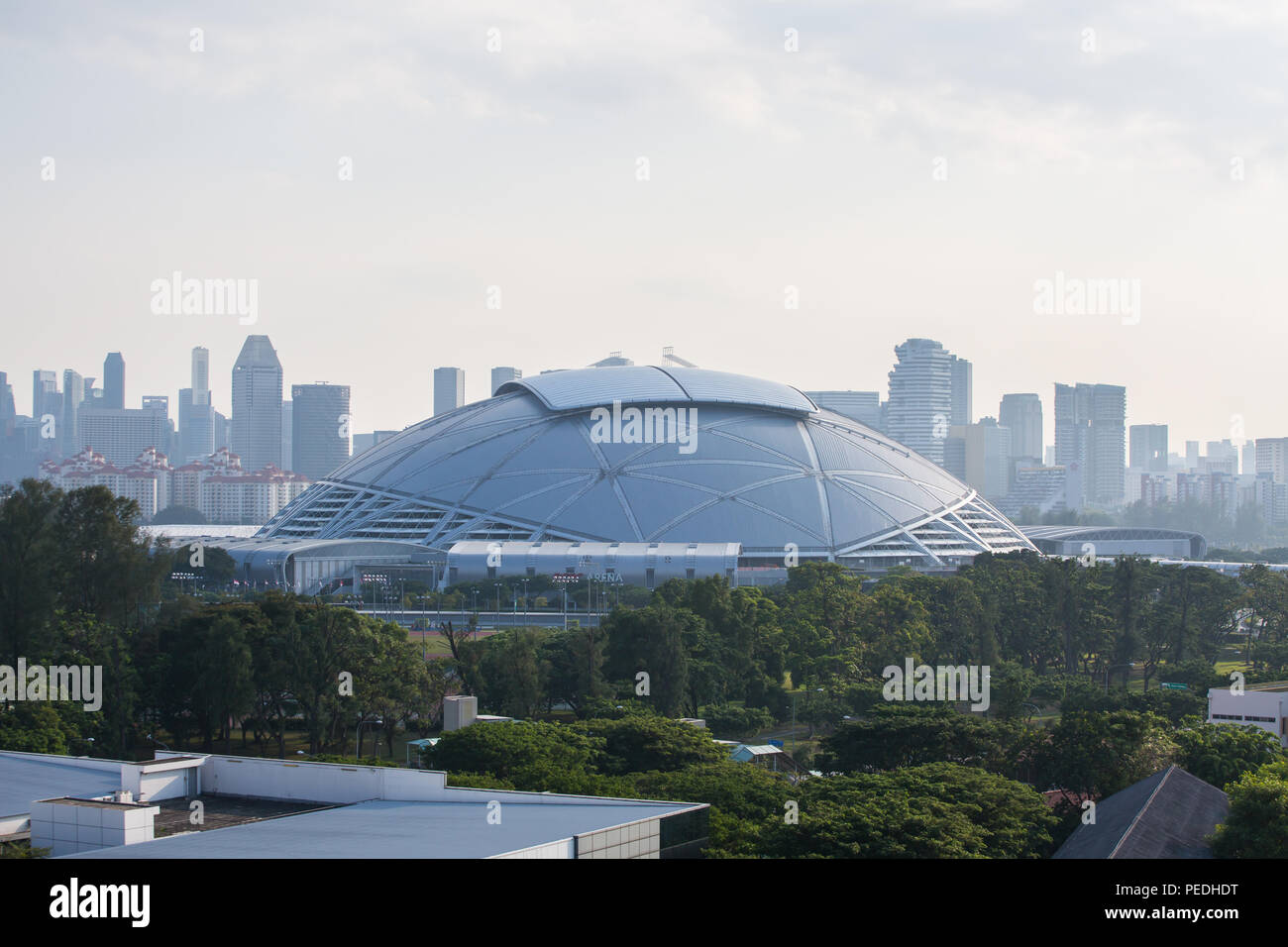 Architecture of Singapore sports hub stadium on a cloudy tropical ...