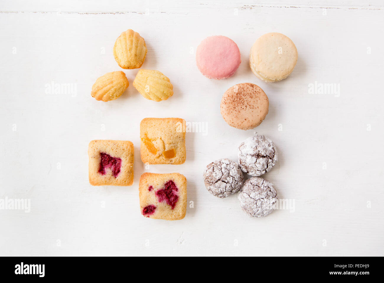A playful selection of cakes and pastries laid out in patterns and ...