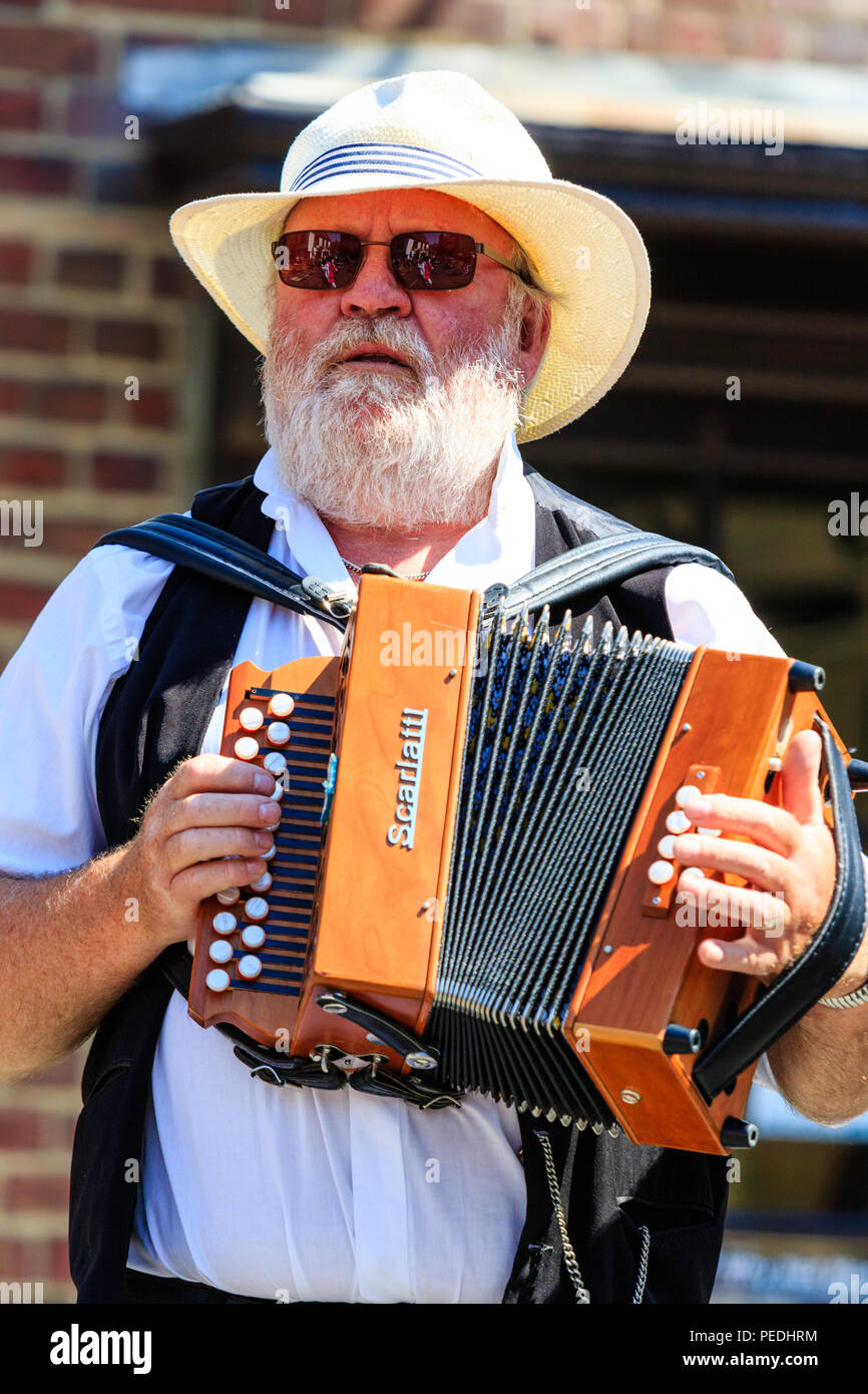 Morris man folk musician playing accordion. Facing but looking away ...