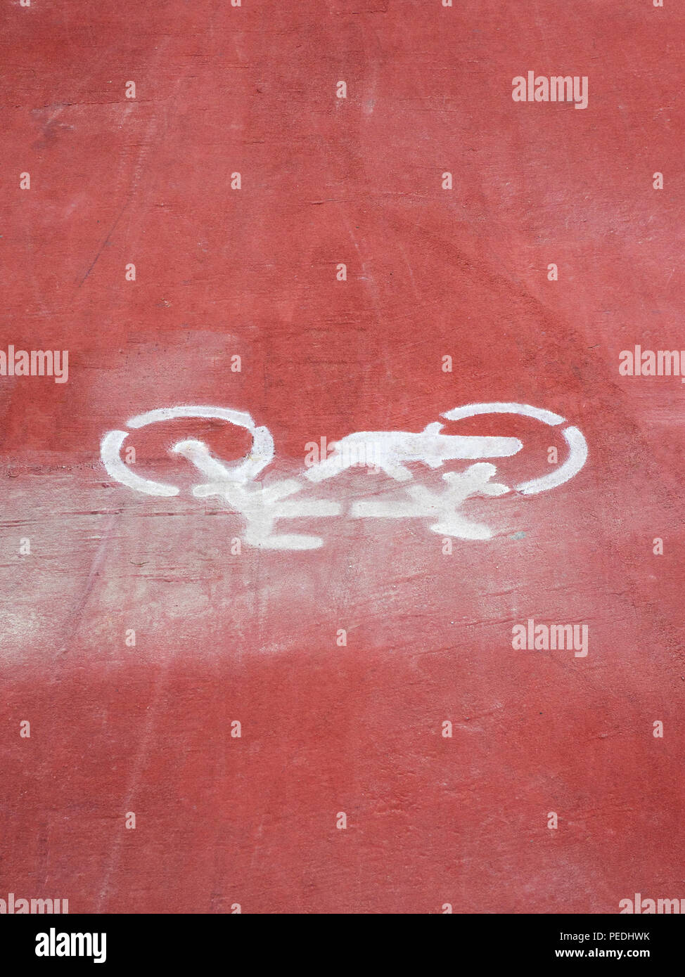 Picture of a bike stencilled on the surface of a red cycle track in ...