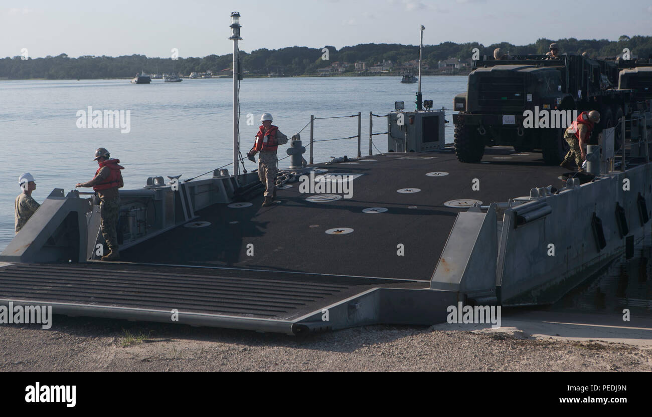 Marines and sailors with Combat Logistics Regiment 25, lower the ramp ...