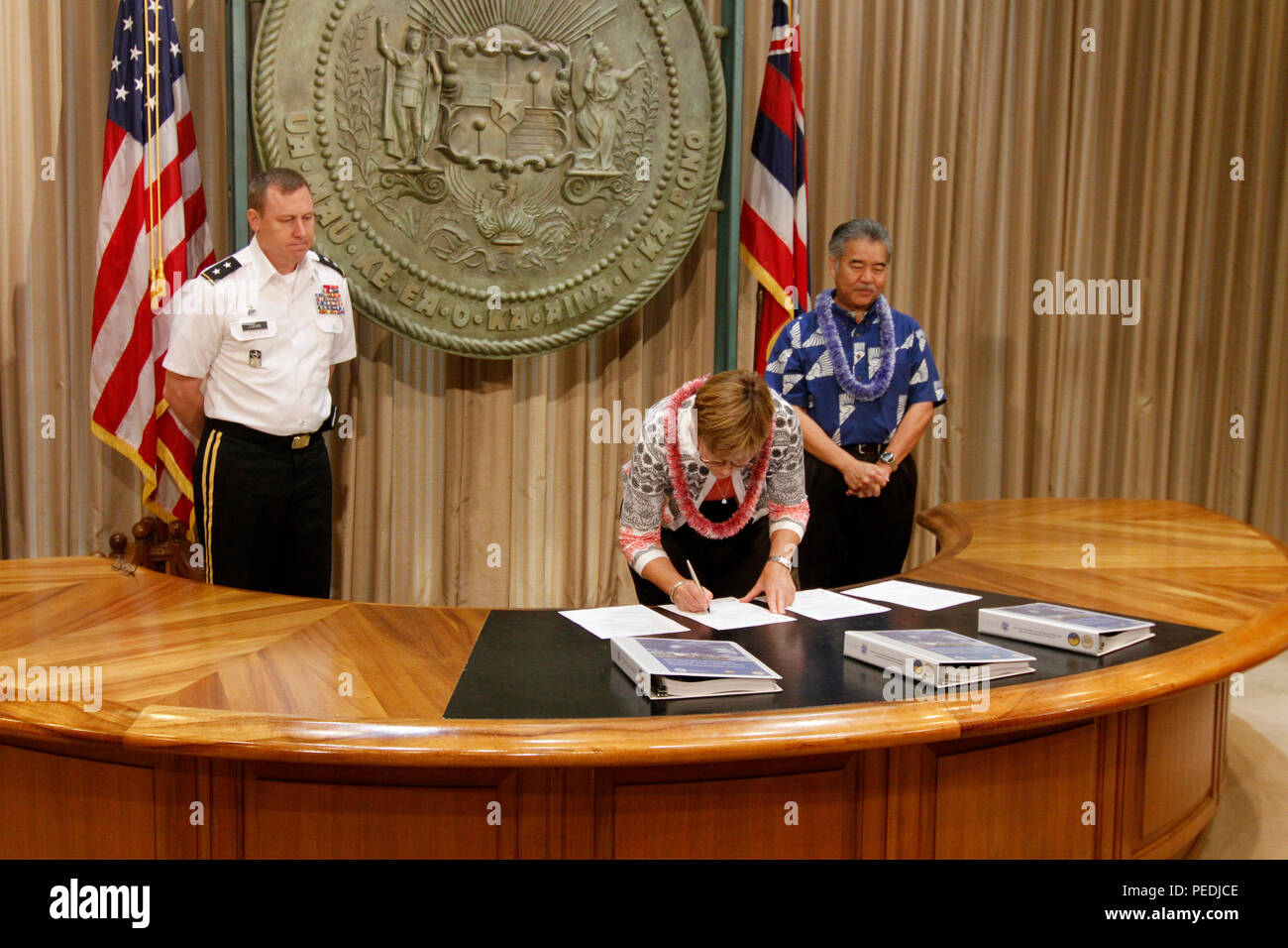 Hawaii Gov. David Ige, along with Karen E. Armes, the acting regional ...