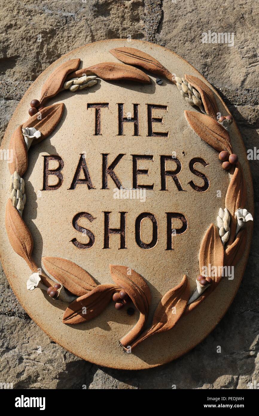 Oval pottery sign hung in Reeth in Yorkshire saying the bakers shop and ...