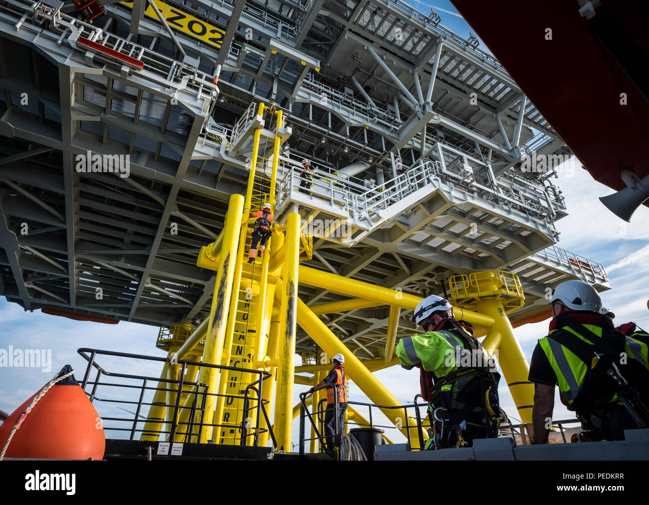 A worker climbing Offshore substation (OSS) Z02 on the Race Bank ...