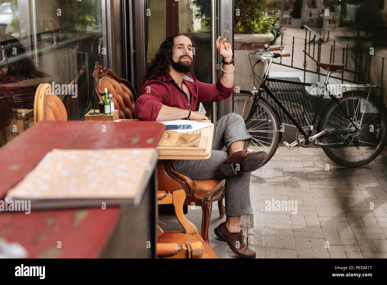 Serious handsome man raising his hand Stock Photo - Alamy