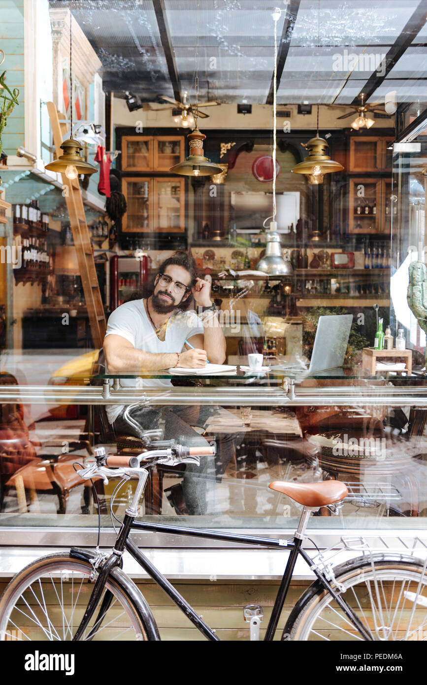 Pleasant creative man looking into the window Stock Photo - Alamy