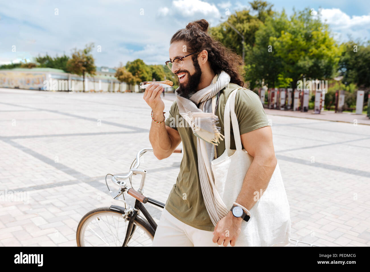 Happy hungry man looking at the eclair Stock Photo - Alamy
