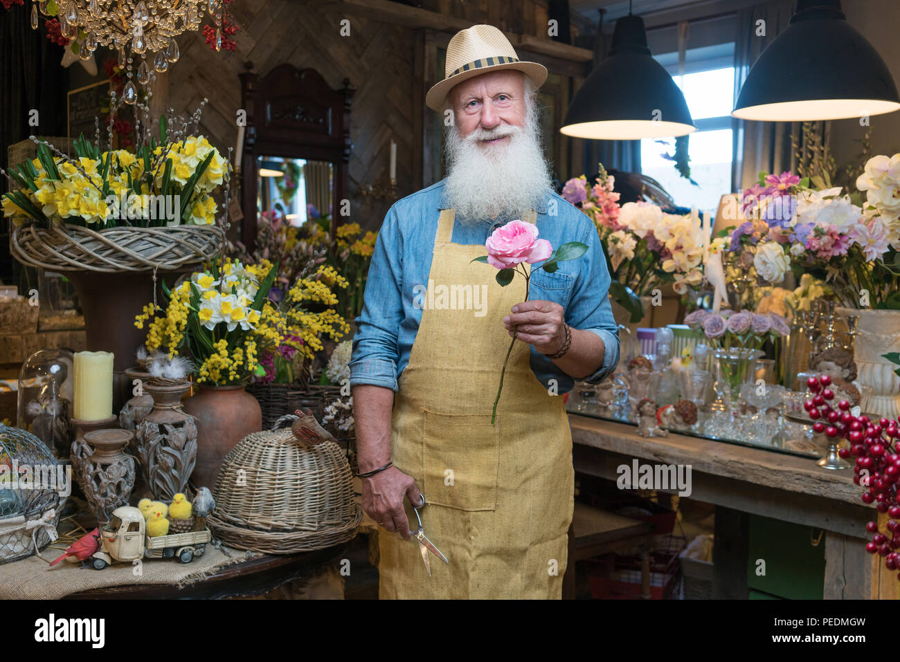 Male florist taking care of flowers in flower shop Stock Photo - Alamy