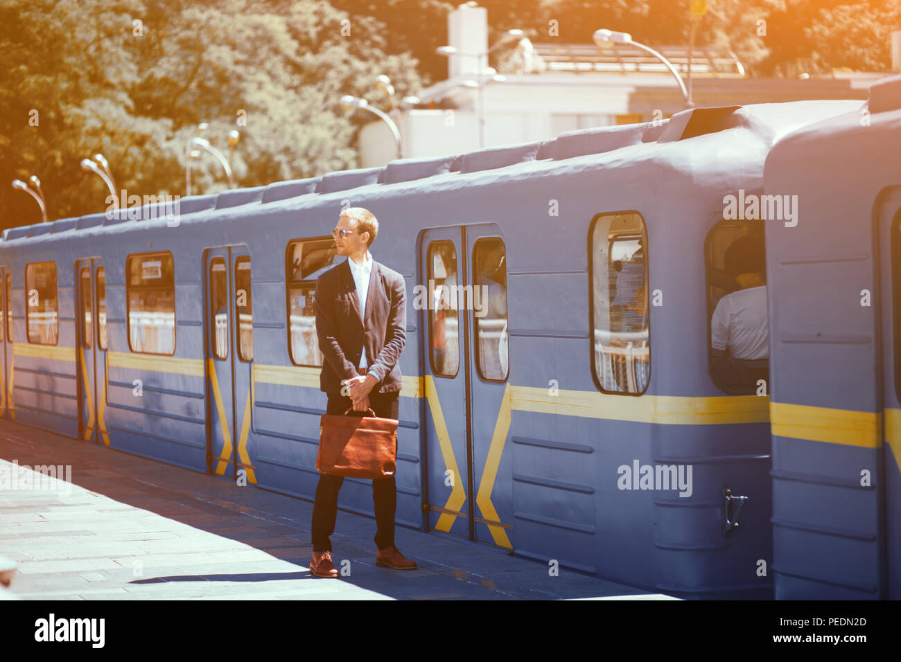 Businessman waiting for train in subway Stock Photo - Alamy