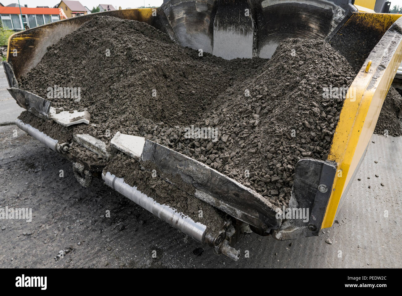 Asphalt paver machine during road construction and repairing works. A ...