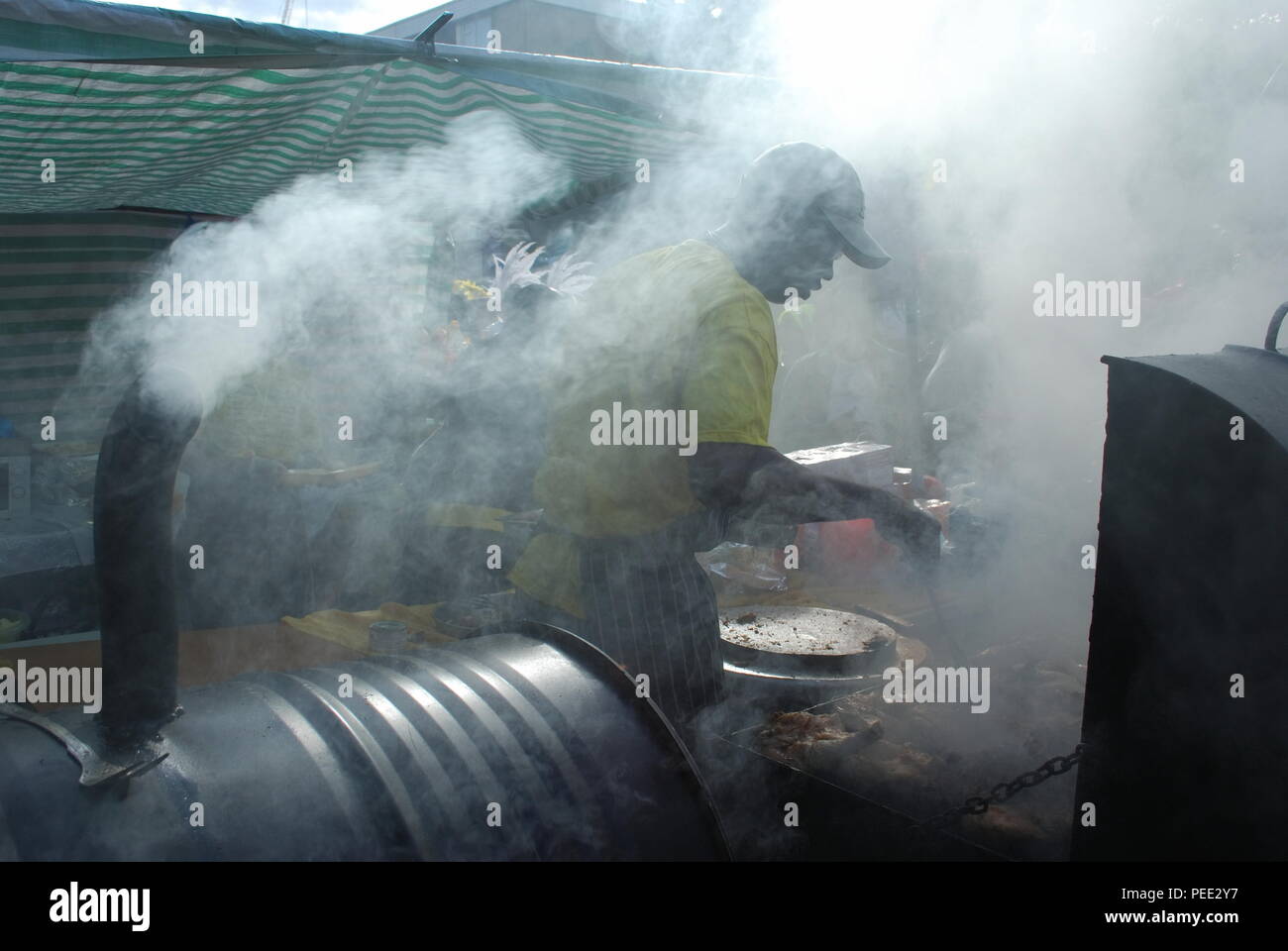 Black man cooking on a barbecue hi-res stock photography and images - Alamy