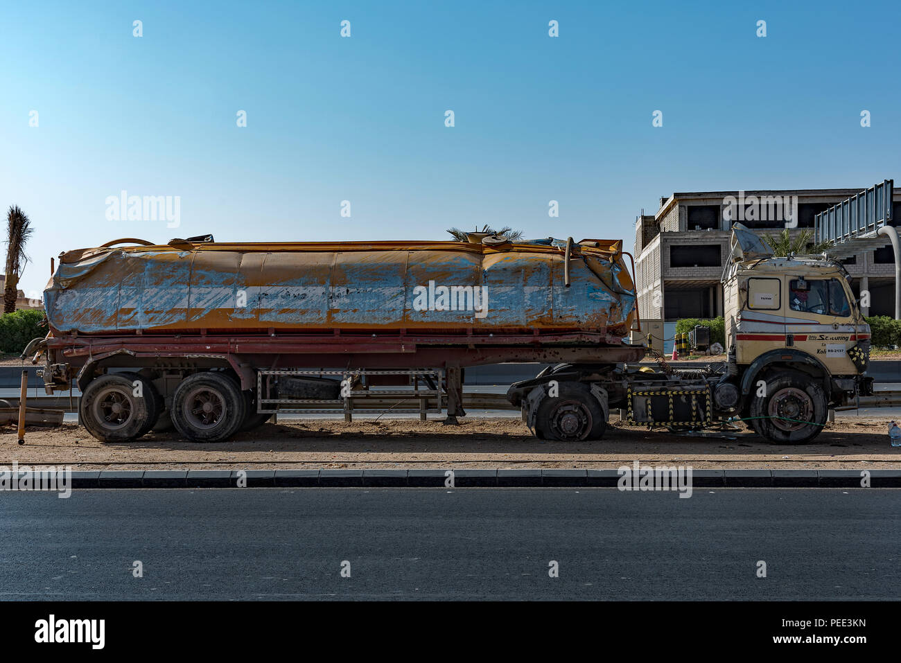 Tanker truck that rolled on a highway waiting to be towed away on the ...