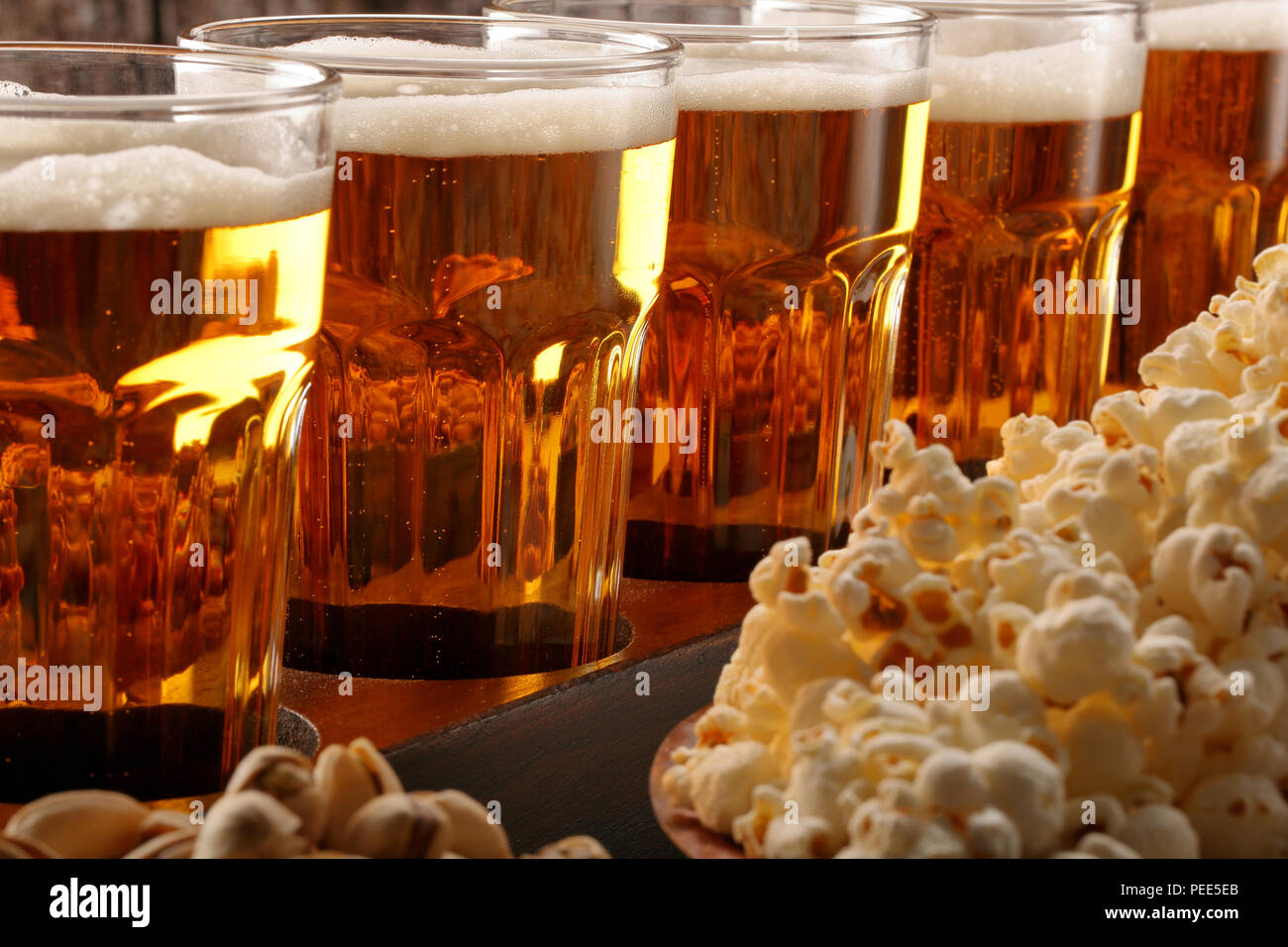 Beer row and snacks on wooden background football fan set Stock Photo ...
