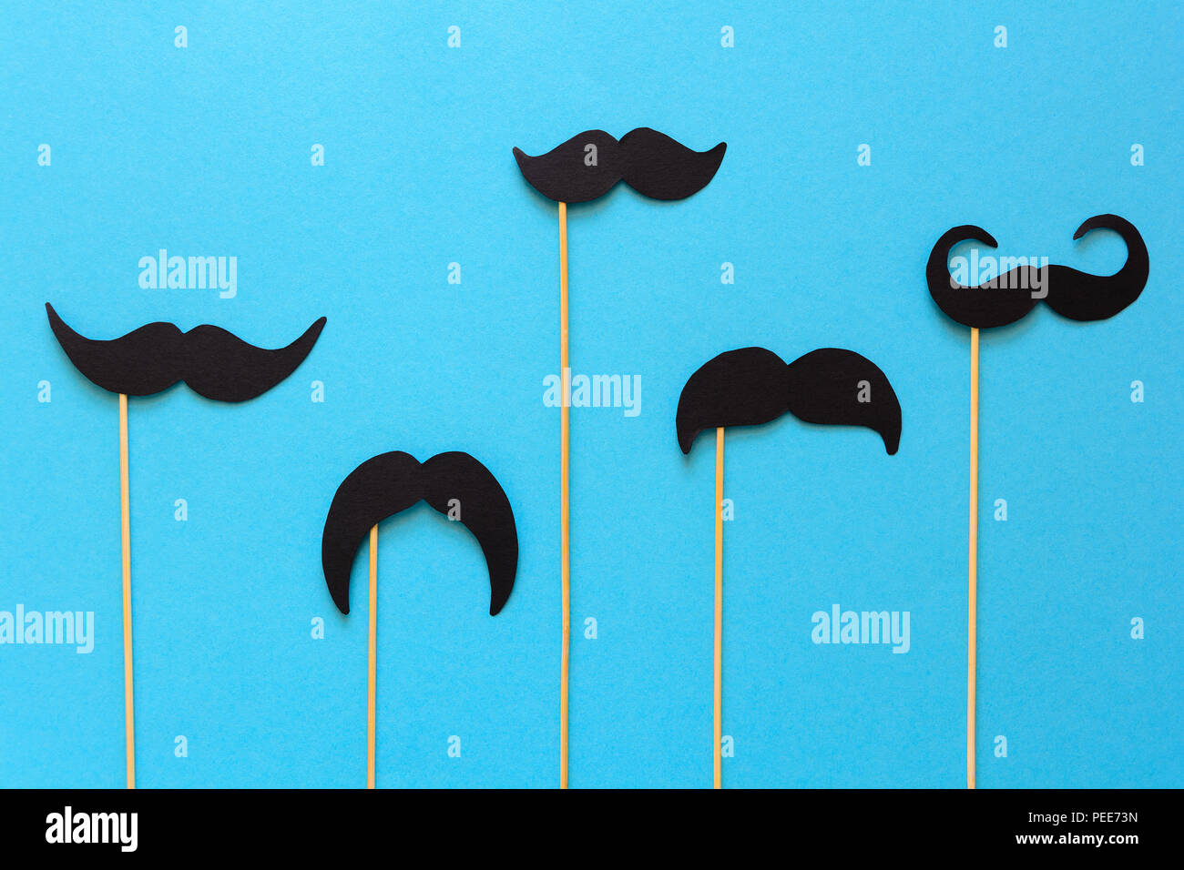 Paper moustache on booth props on blue paper background. Cut out style ...