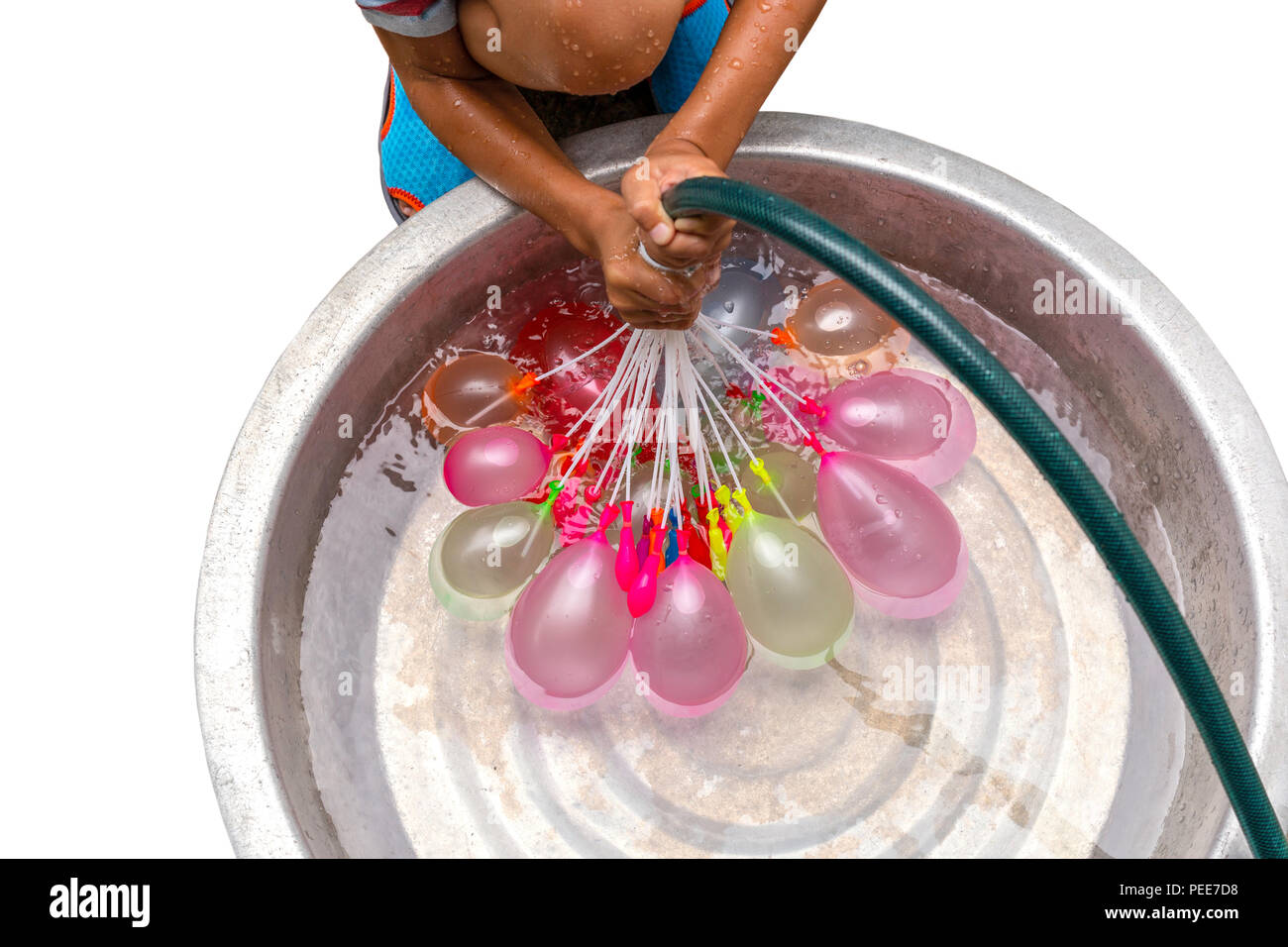 Little boy with water hose filling colorful water balloons up isolated ...