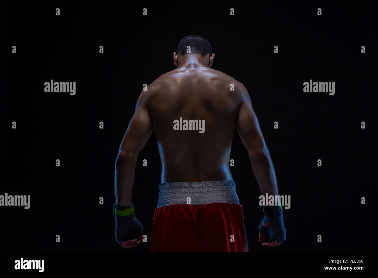 Rear view of strong young male boxer. Fitness male model wearing boxing ...
