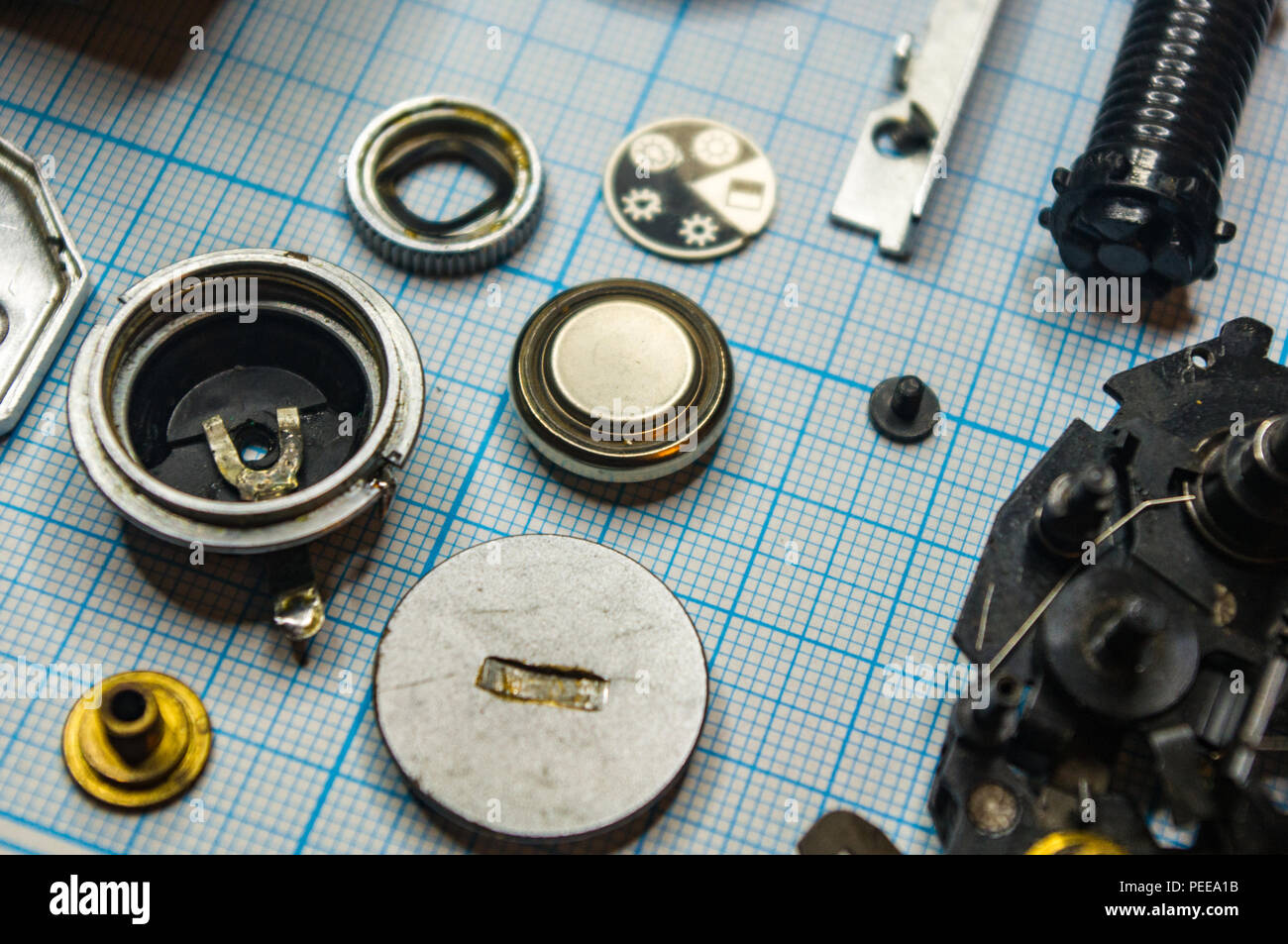 parts are completely disassembled old retro film SLR camera on graph ...