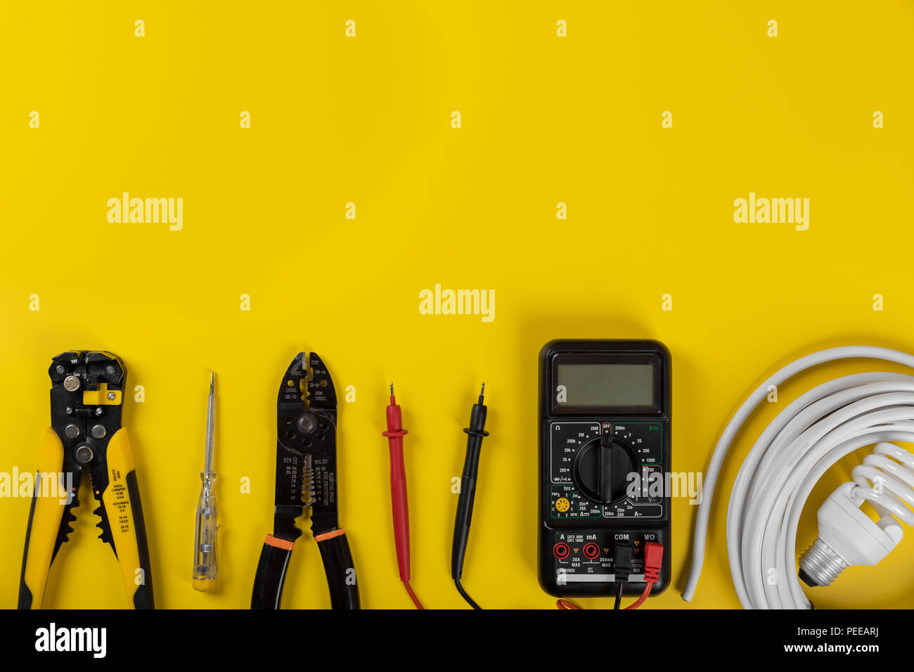 electrical installation tools on yellow background with copy space ...