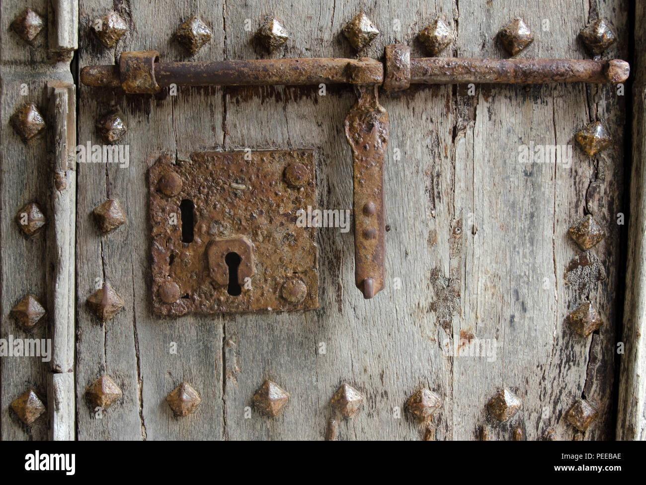 old lock on a studded wooden door Stock Photo - Alamy