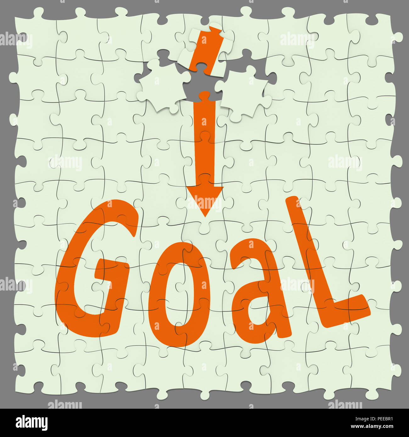 Cardboard jigsaw puzzles with red motivation text "Goal" assembled on ...