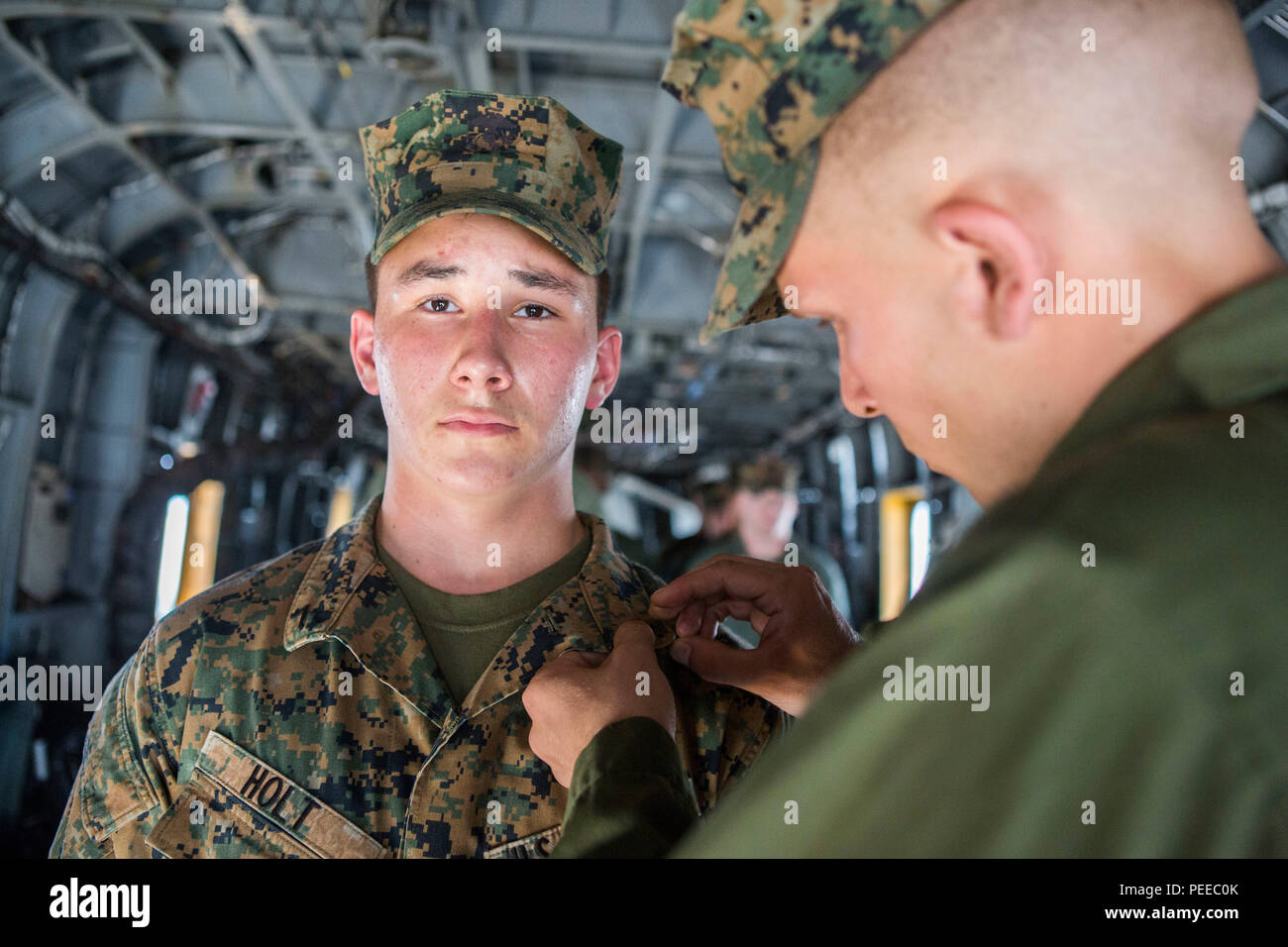 U.S. Marine Corps Cpl. Nicholas C. Carson, right, aircraft ordnance ...
