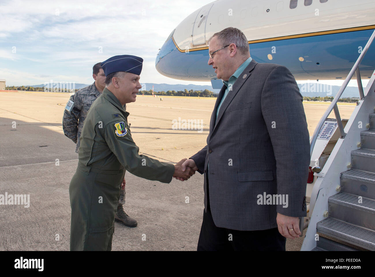 Deputy Secretary of Defense Bob Work is greeted at Moffett Field ...