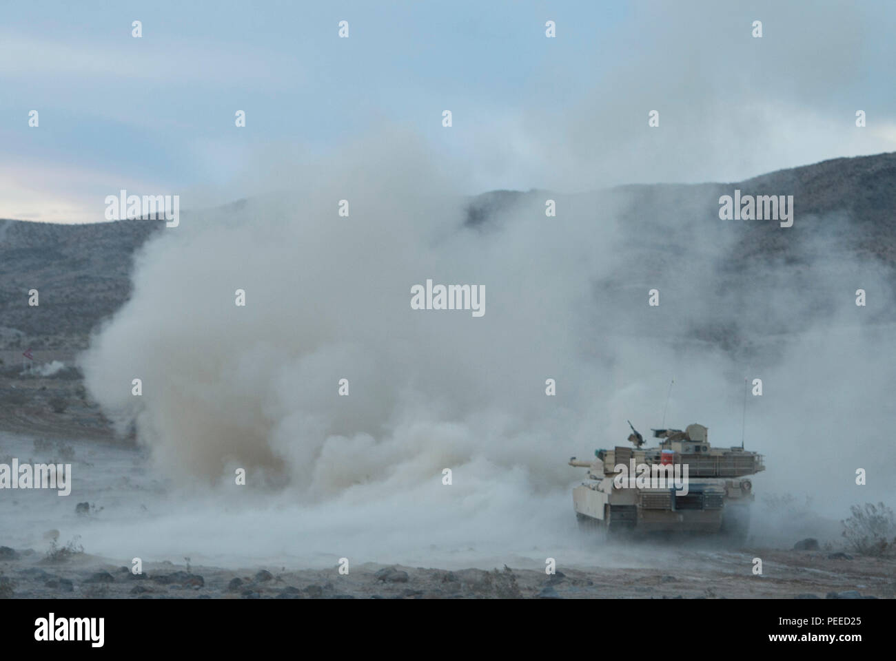 An M1A1 Abrams main battle tank traverses desert terrain at Fort Irwin ...