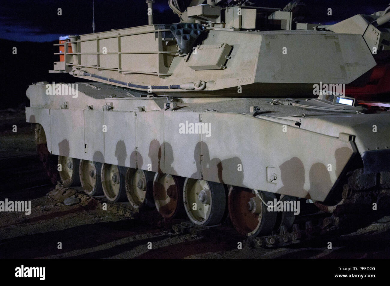 The shadow of M1A1 Abrams tank crew members can be seen on a tank at ...