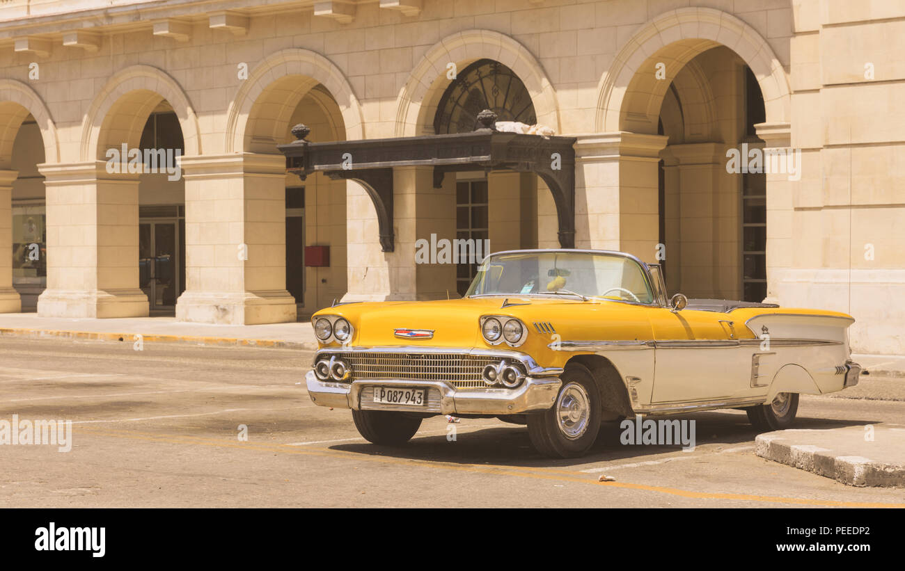 Yellow Chevrolet Impala Convertible American classic car in front of ...