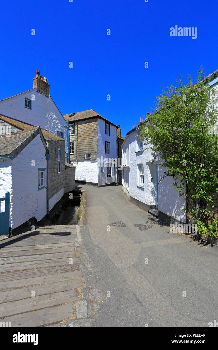 Whitewashed cottages on a narrow street in Port Issac, location of the ...