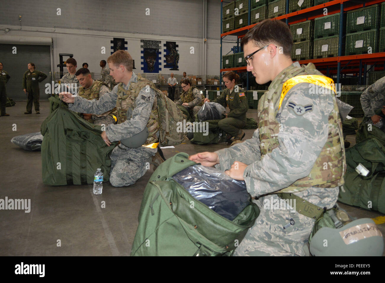 Airmen from the 43rd Airlift Group inspect their deployment bags while ...