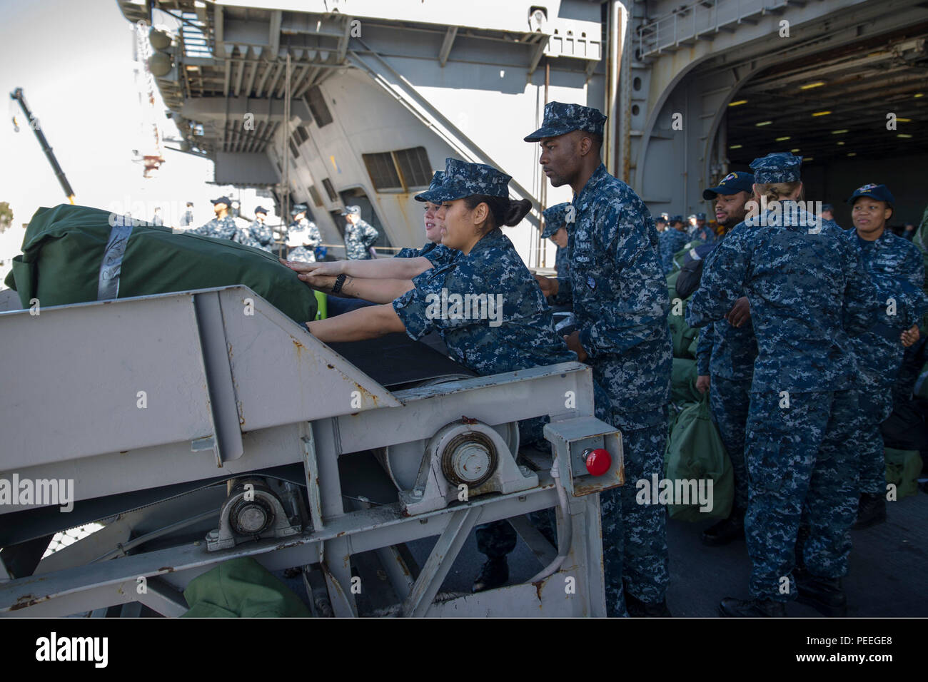 150812-N-YB023-088 SAN DIEGO (Aug. 12, 2015) Sailors load cargo onto a ...