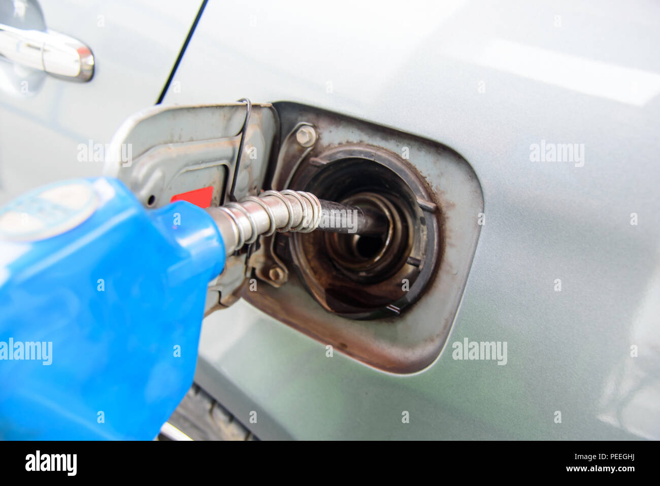 Oil dispenser at the car / refuel at oil station Stock Photo - Alamy