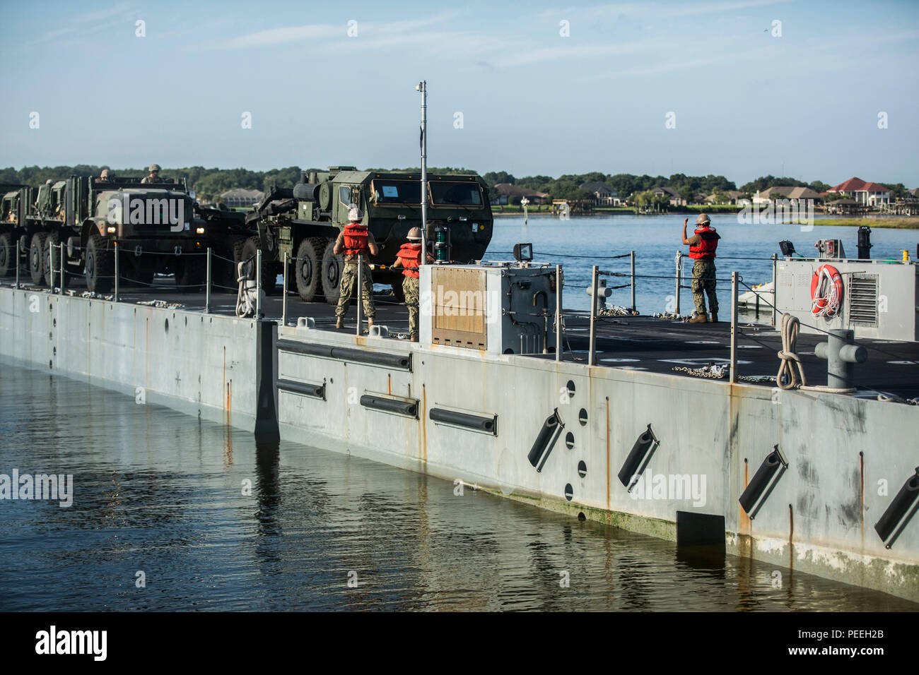 A sailor with Naval Beach Group-2 directs Marines in a Logistics System ...