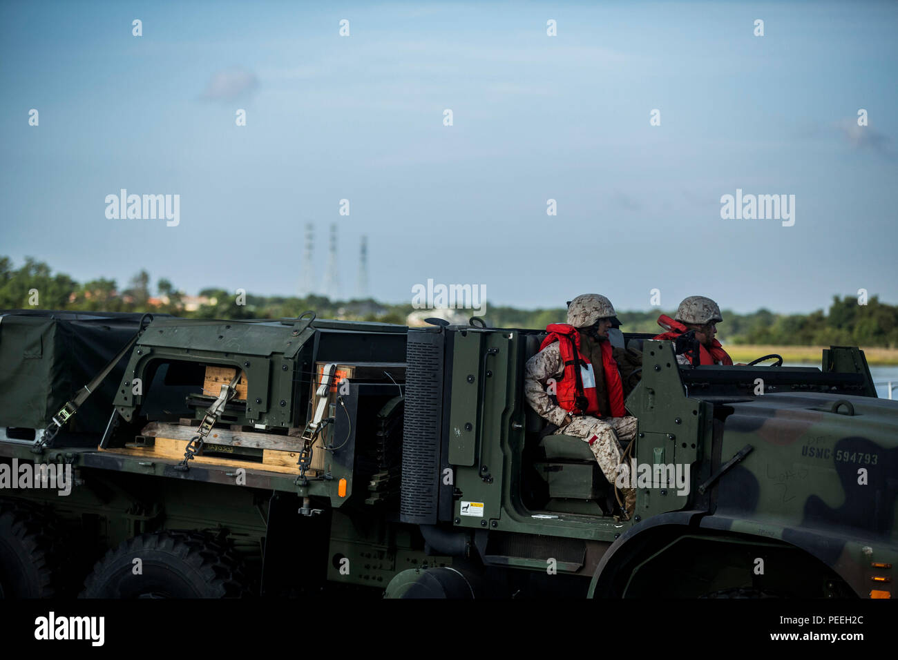 Marines with Combat Logistics Regiment 25 drive a 7-ton truck off of an ...