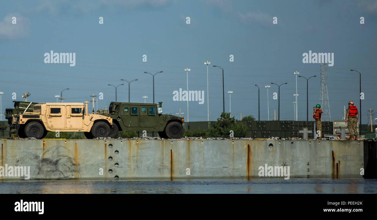 A sailor with Naval Beach Group-2 directs Marines in a Logistics System ...