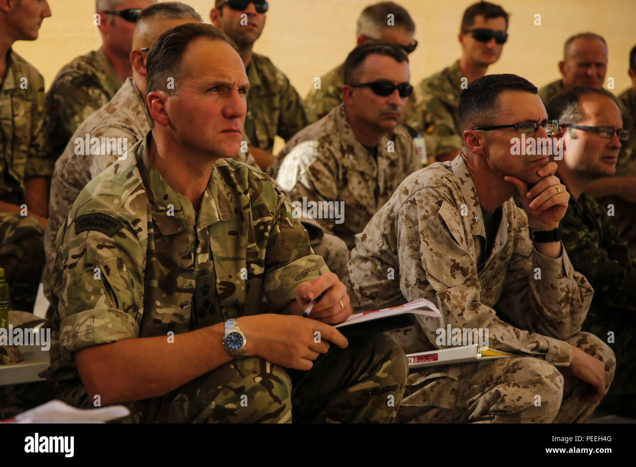 Brigadier Charlie Stickland RM (Left) observes the terrain model with ...