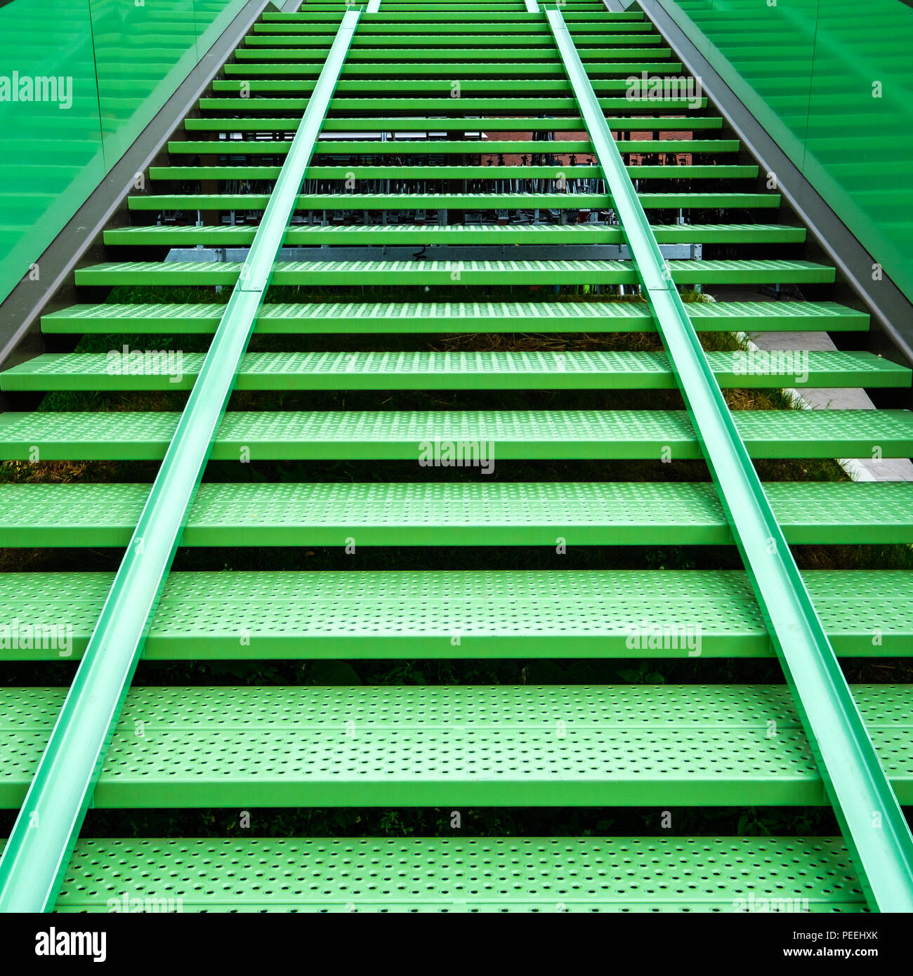 Bicycle gutter on a modern steel green staircase in a bicycle storage ...