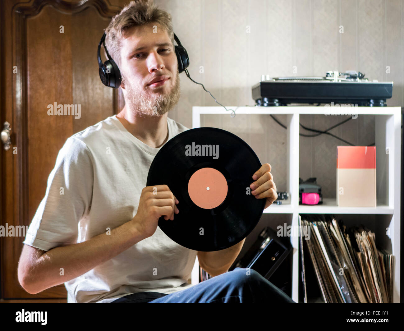 Man sitting on record collection hi-res stock photography and images ...