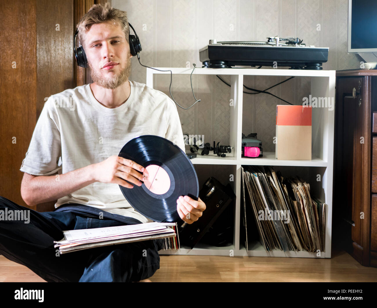 Man sitting on record collection hi-res stock photography and images ...