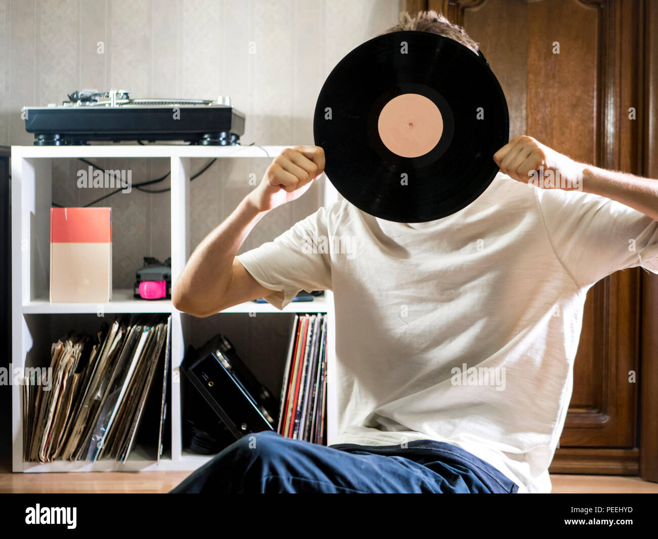 Man sitting on record collection hi-res stock photography and images ...