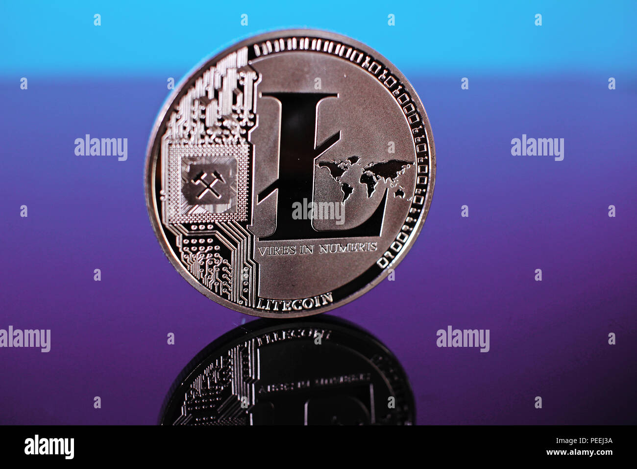 Litecoin crypto currency coin on reflective colorful background Stock ...