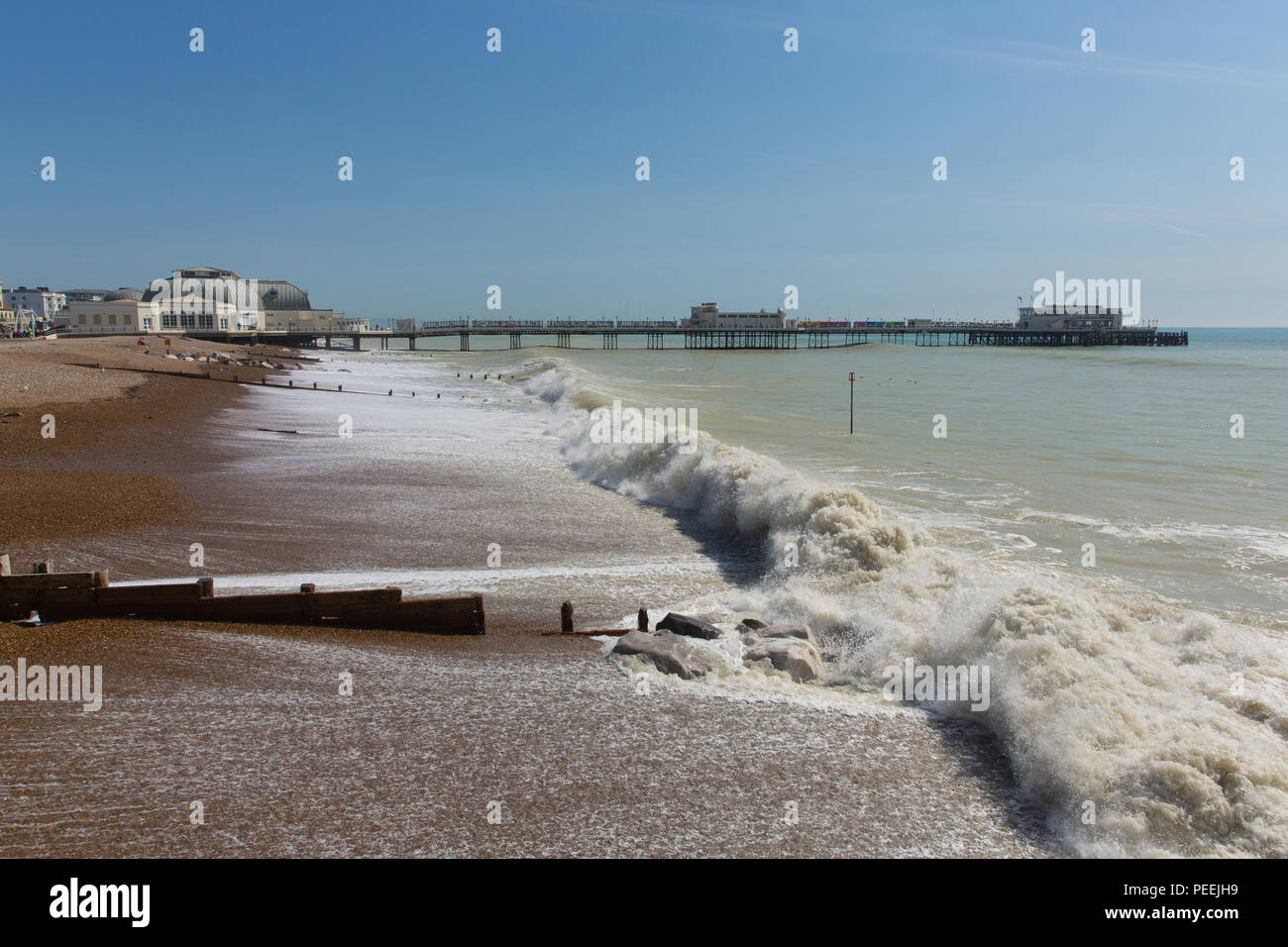 Worthing West Sussex with breaking waves and pier in this tourist ...
